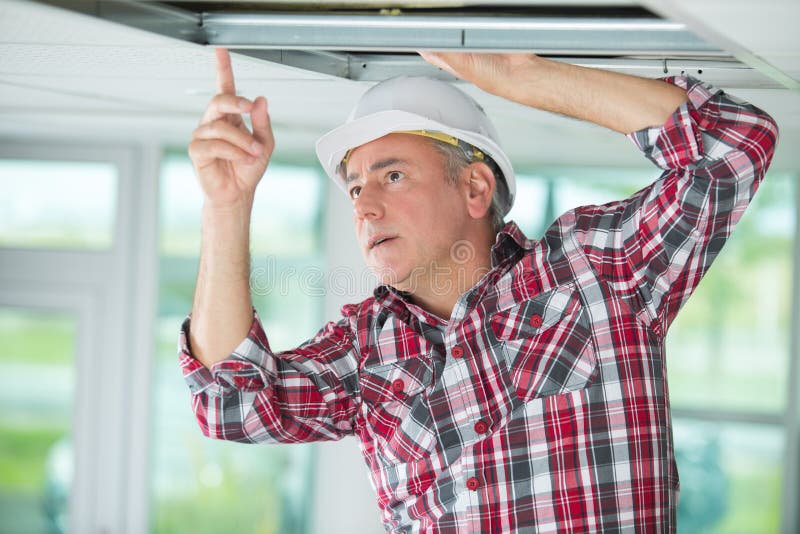 Builder Looking Up at Ceiling Inside Unfinished Home Stock Image ...