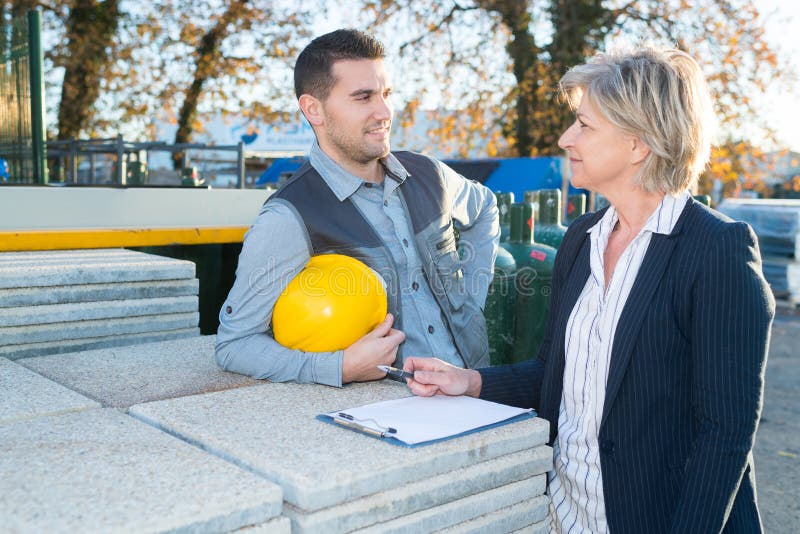 Builder Looks at Plans with Architects Stock Image - Image of ...
