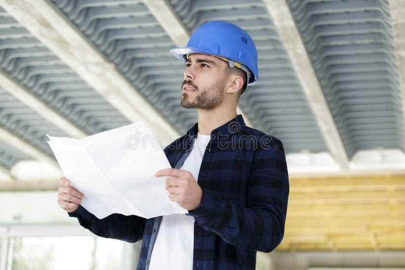 Builder Looks at Plans for New Home Stock Photo - Image of caucasian ...