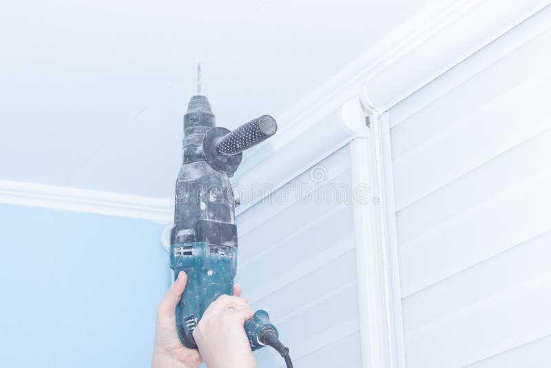 The Builder is Making Hole in Ceiling with Hammer Drill Perforator ...