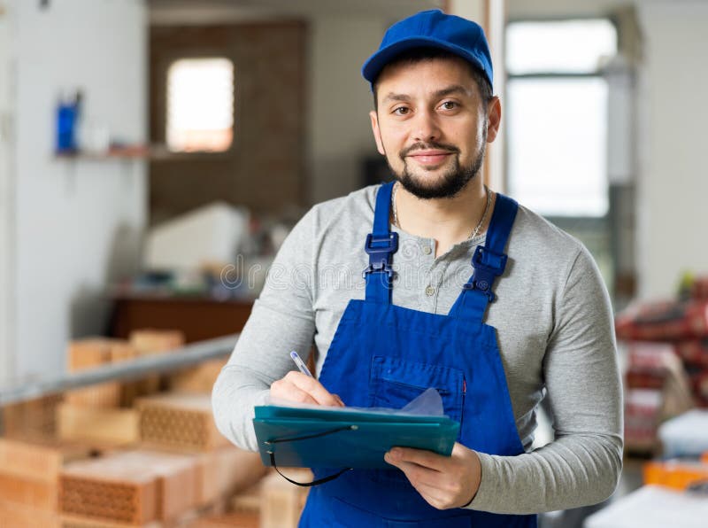 Builder Making Notes on Indoor Construction Site Stock Photo - Image of ...