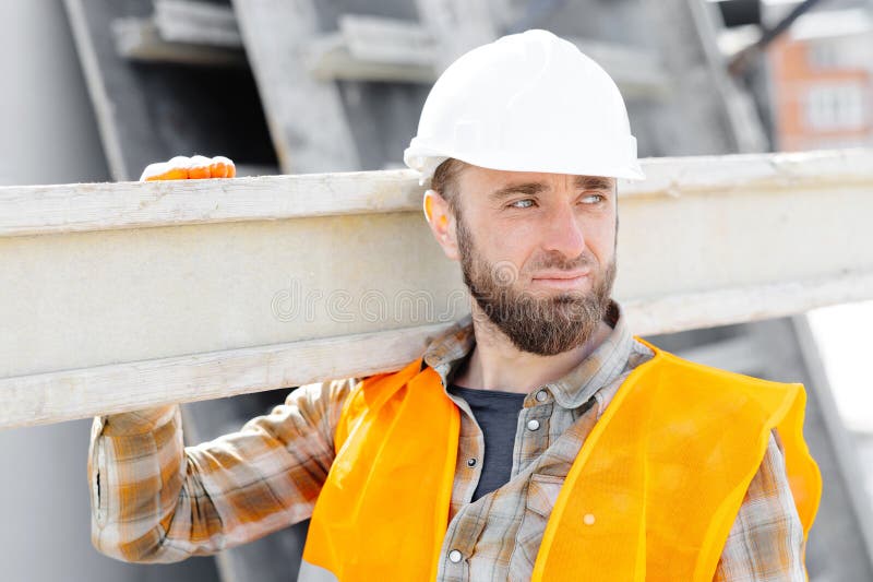 Builder Man in Hardhat and Vest Carrying Timber on Building Site in His ...