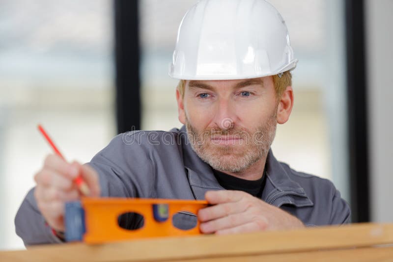 Builder man with level stock photo. Image of mason, equipment - 222653308