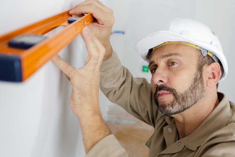 Builder man with level stock image. Image of remodeling - 263004963