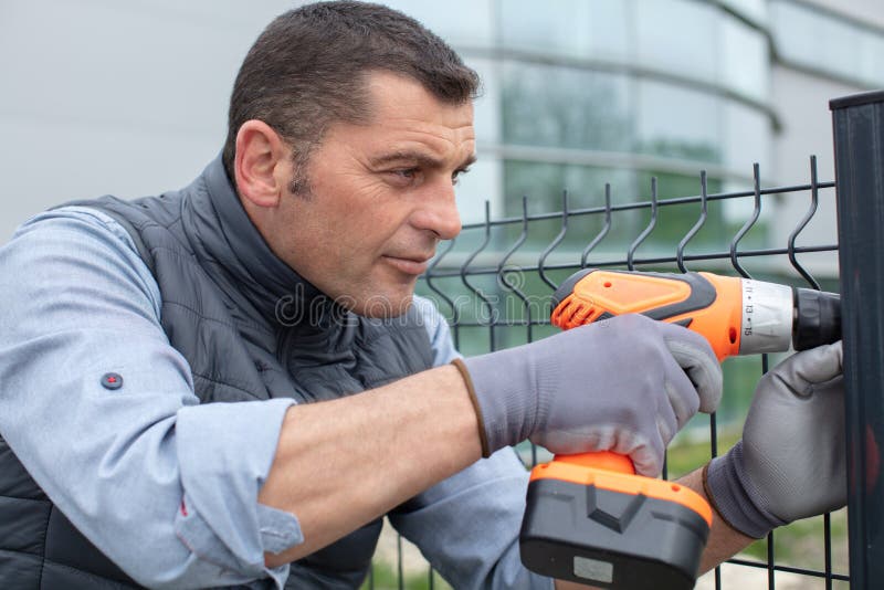 Builder Man Working Outdoors with Electric Dril Stock Image - Image of ...