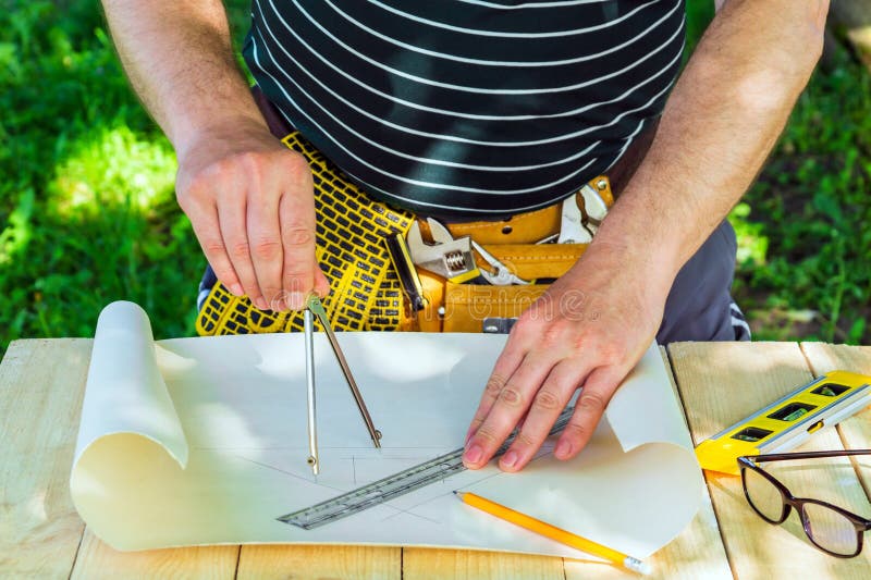 Builder Master Measures the Distance in the Drawing Using a Compass ...