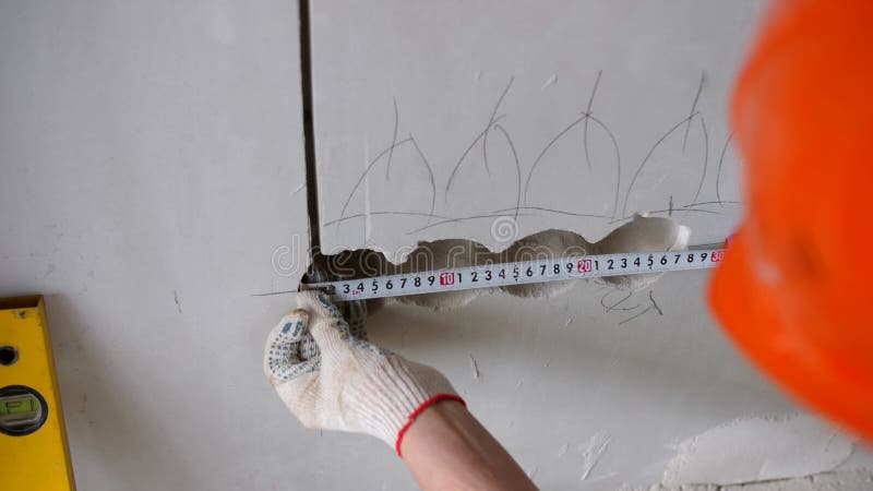 The Builder Measures the Distance of the Sockets with a Tape Measure ...