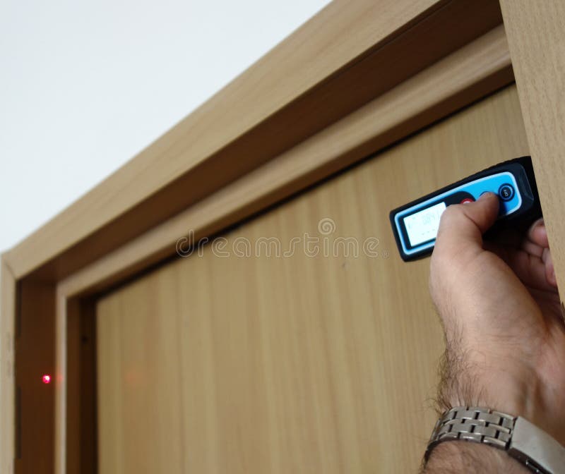 The Builder Measures the Door Opening with a Laser Ruler. Construction ...