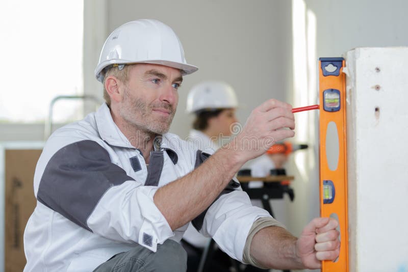 Builder Measuring Wall with Level Stock Image - Image of renovation ...
