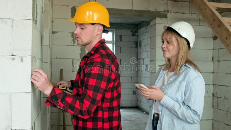 Construction Workers Busy with Wall Measurement in Unfinished ...