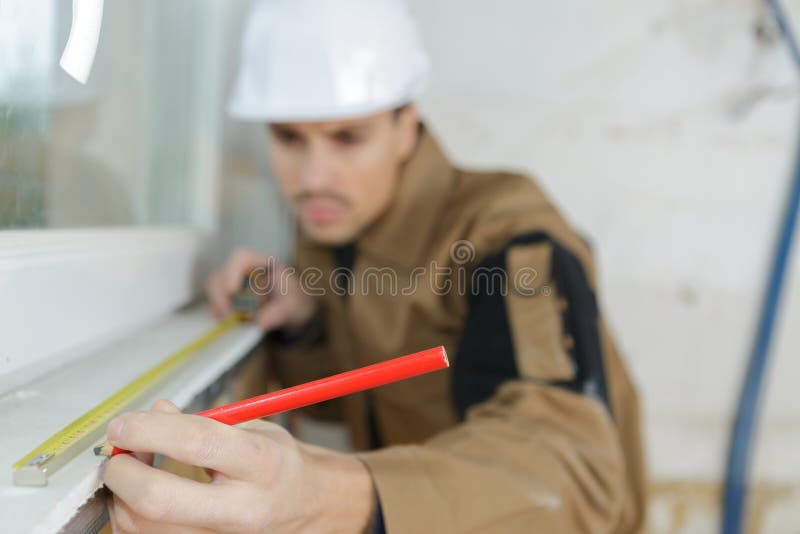 Builder Measuring Window Using Tape Measure and Pencil Stock Photo ...