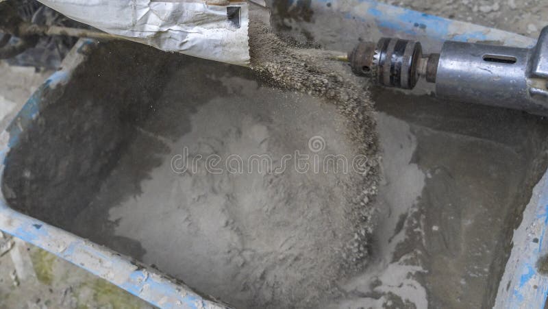 The Builder Mixes the Construction Mixture in a Container for Guiding ...