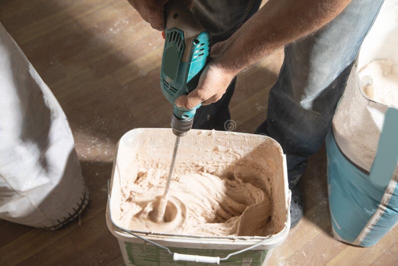 Builder Mixes Gypsum Putty in a Bucket Stock Image - Image of material ...