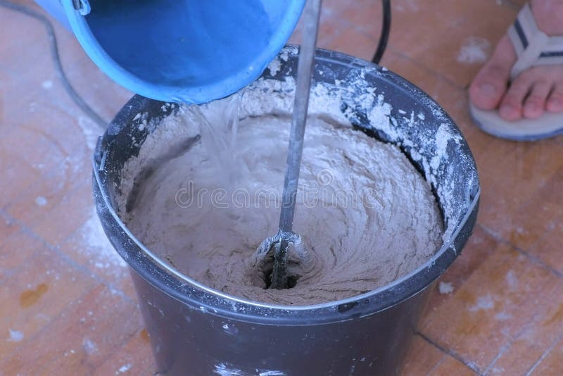 Builder Mixing Cement Plaster in Bucket Using an Electric Mixer ...