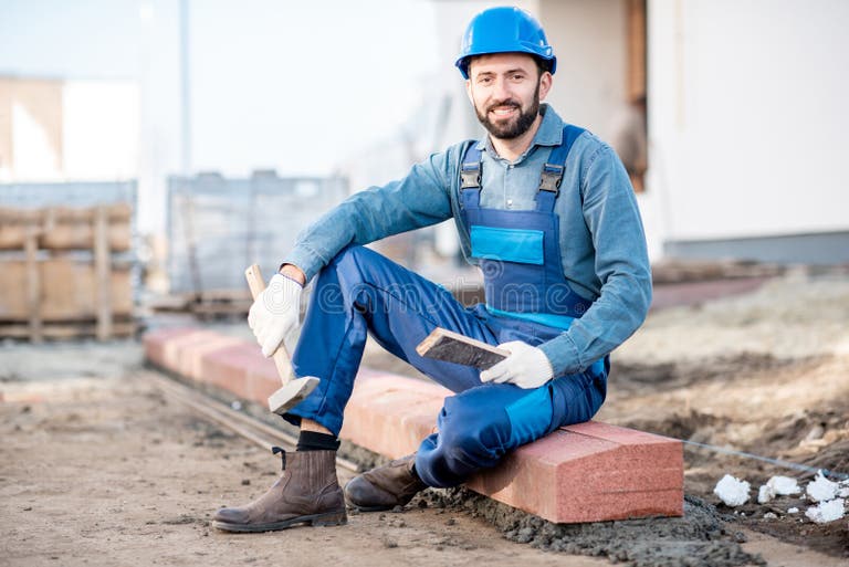 Builder Mounting Road Borders Stock Photo - Image of laying, blue ...