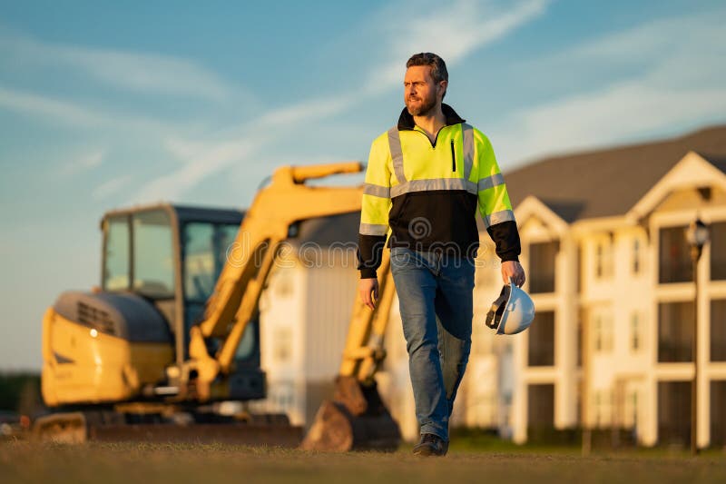 Builder Near Excavator. Builder Worker with Excavator. Builder in ...