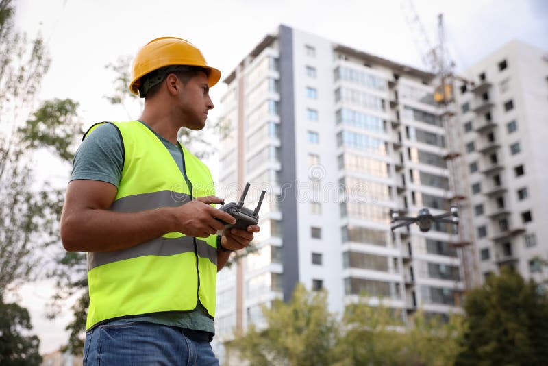 Builder Operating Drone with Remote Control at Construction Site ...
