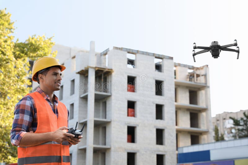 Builder Operating Drone with Remote Control at Construction Site ...