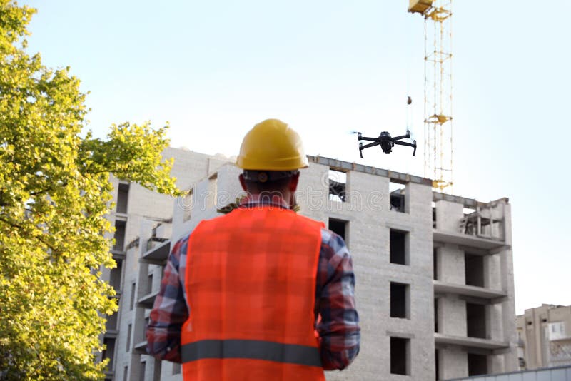Builder Operating Drone with Remote Control at Construction Site ...