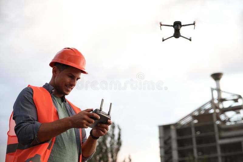 Builder Operating Drone with Remote Control at Construction Site ...