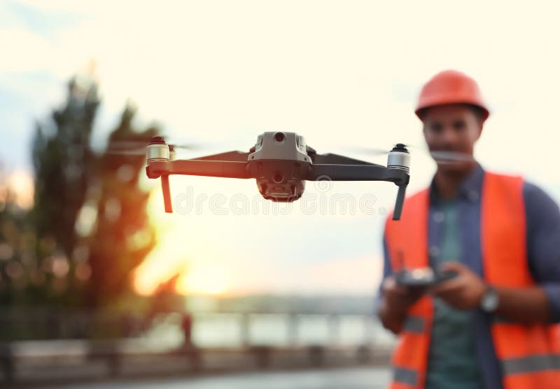 Builder Operating Drone with Remote Control at Construction Site, Focus ...