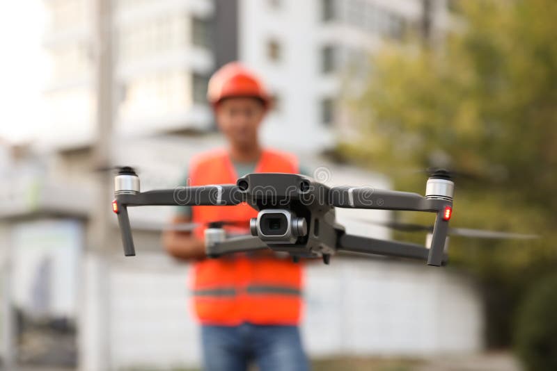 Builder Operating Drone with Remote Control at Construction Site, Focus ...