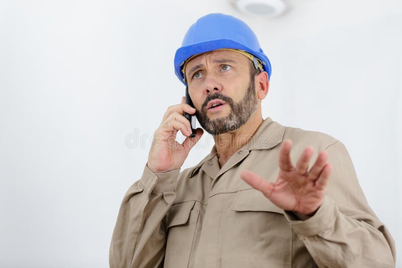 Builder on phone by ladder stock image. Image of floor - 308545219