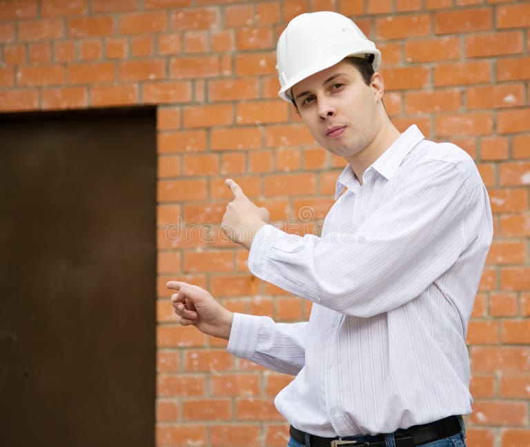 Builder Pointing To Door in Brick Wall Stock Image - Image of outdoor ...