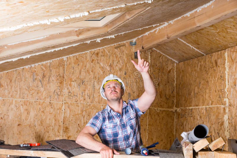 Builder Pointing Up at Ceiling in Unfinished Home Stock Photo - Image ...