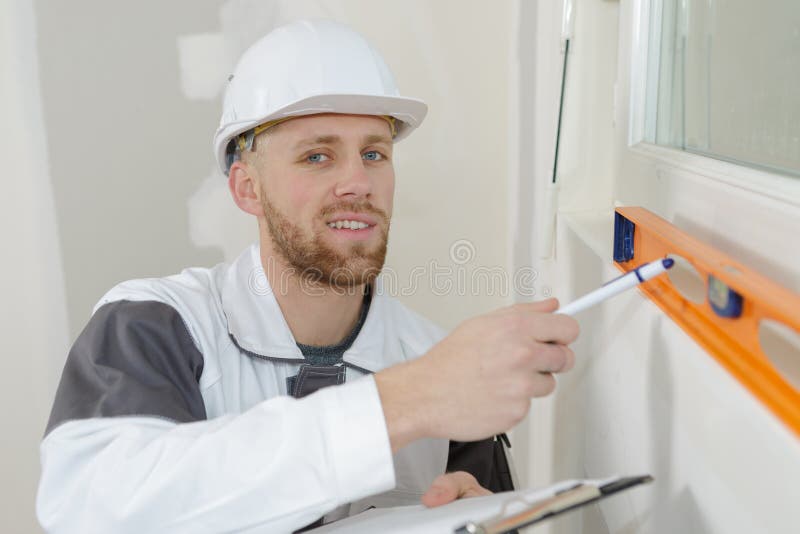 Builder Posing and Pointing To Spirit Level Stock Image - Image of flat ...