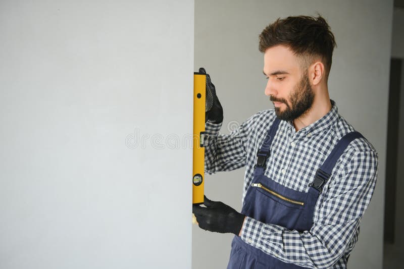 Builder Posing with Spirit Level at Construction Site Stock Photo ...