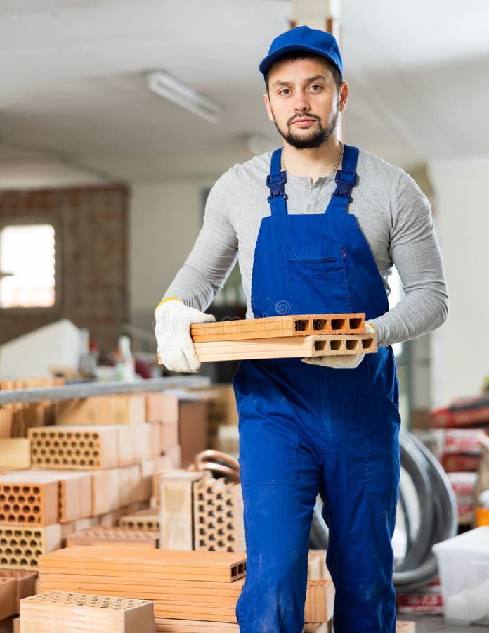 Builder Preparing Bricks for Work in Building Under Reconstruction ...