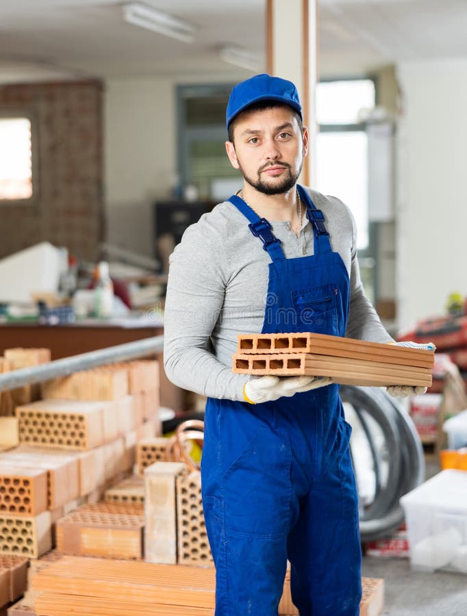 Builder Preparing Bricks for Work in Building Under Reconstruction ...
