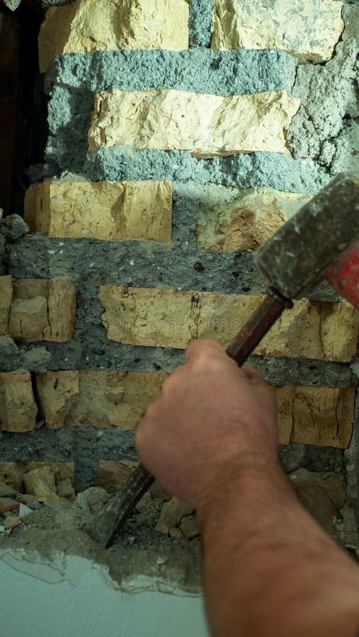 Builder Punches a Hole in the Wall with a Hammer, Close Up Stock Photo ...
