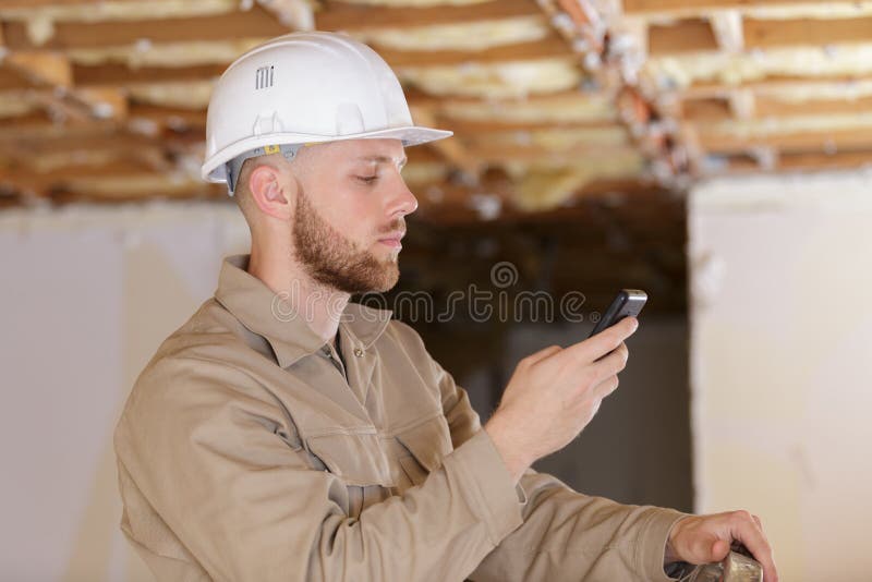 Builder on mobile phone stock image. Image of working - 21649259