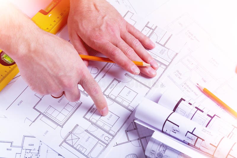 Builder& X27;s Hands on the Background of a House Plan. Construction ...
