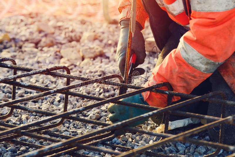 Builder`s Hands Fixing Steel Reinforcement Bars at Construction Site ...