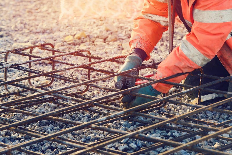 Builder`s Hands Fixing Steel Reinforcement Bars at Construction Site ...