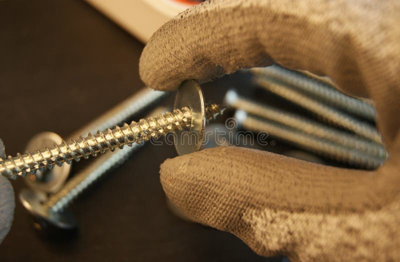 Builder S Work Process. Putting the Washer on the Screw. Stock Image ...