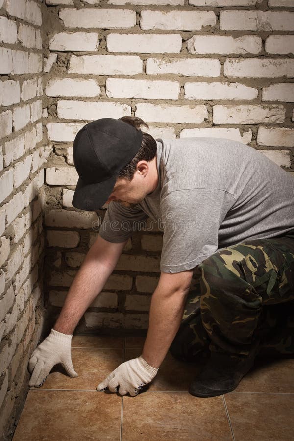 Builder Setting Tile on Cement Floor. Stock Photo - Image of activity ...