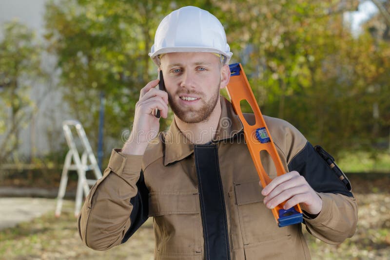Builder on mobile phone stock image. Image of working - 21649259