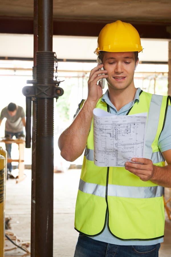 Builder on Site Using Mobile Phone Stock Image - Image of happy ...