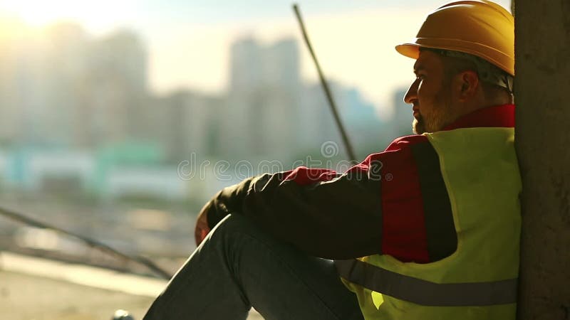Builder Sits on the Floor and Looks Ahead Stock Video - Video of person ...