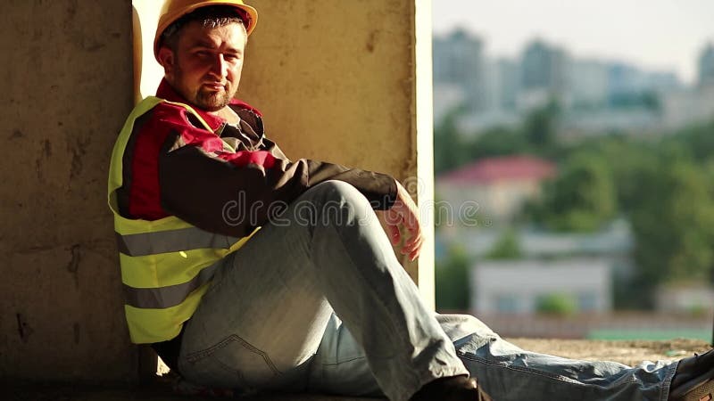 Builder Sits on the Floor and Looks at the Camera Stock Video - Video ...