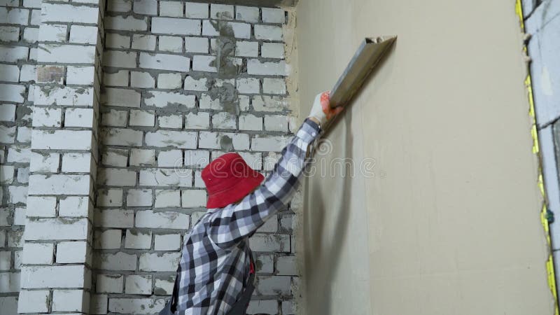 Plasterer Smoothing Plaster on Interior Wall with Construction Ruler ...