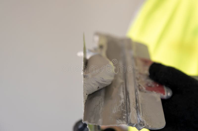 Builder with a Spatula in His Hands Stirs the Plaster Mixture on a ...