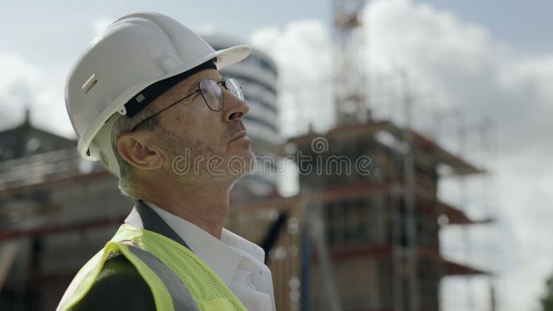 Builder Standing on Construction Site and Looking Around Stock Footage ...