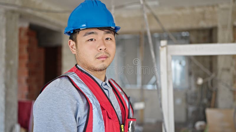 Builder Standing with Serious Expression at Construction Site Stock ...