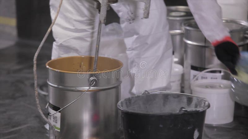The Builder Stirs the Building Mixture in a Bucket. a Construction ...