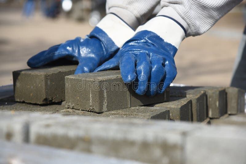 The Builder Takes in His Own Hands Paving Slabs, Bricks from the Pallet ...
